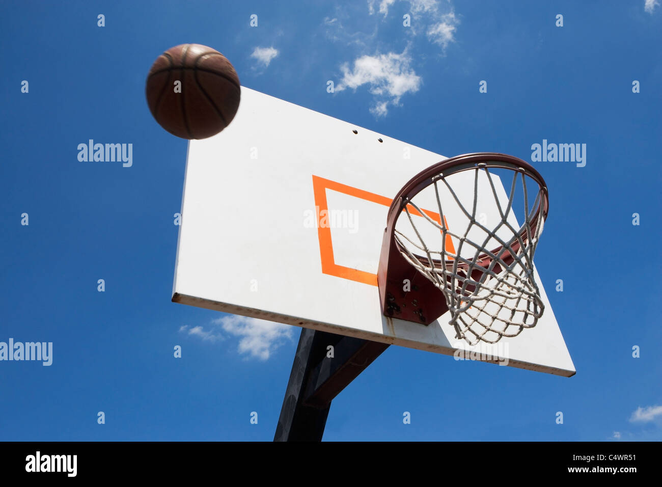 USA, Florida, Miami, Low angle view of basketball flying into hoop ...