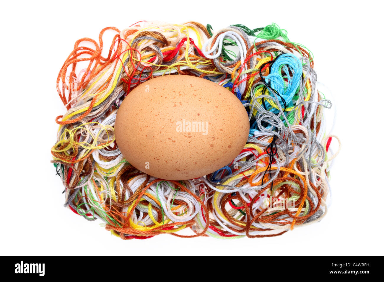 Egg and threads on a white Stock Photo - Alamy