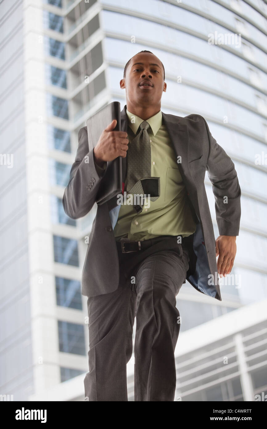 USA, Utah, Salt Lake City, Young businessman running in office building ...