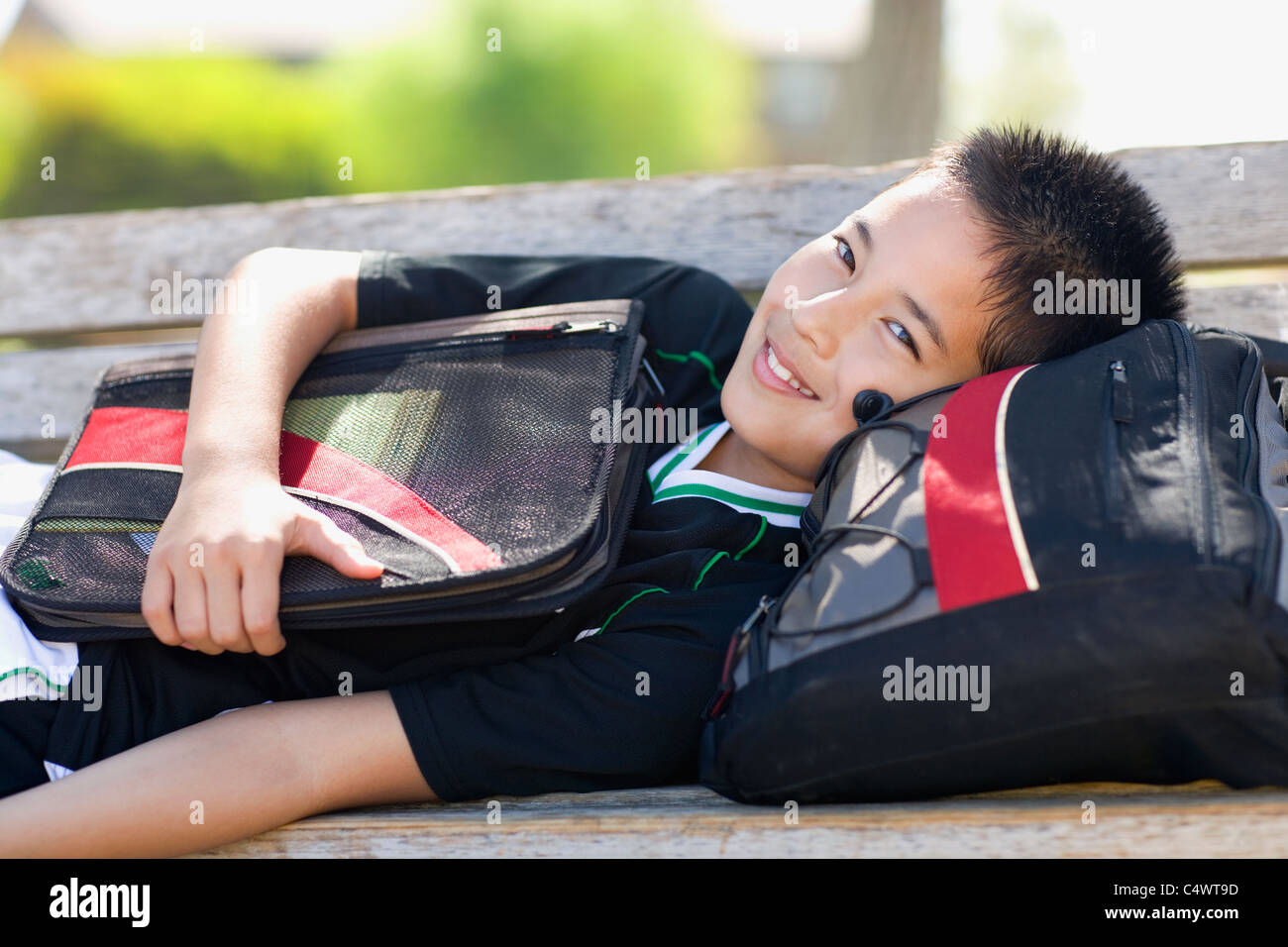Boy lying down on bench hi-res stock photography and images - Alamy