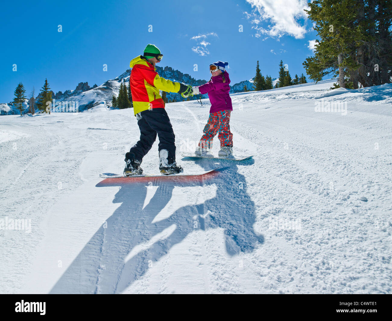 USA,Colorado,Telluride,Father and daughter (10-11) snowboarding Stock ...