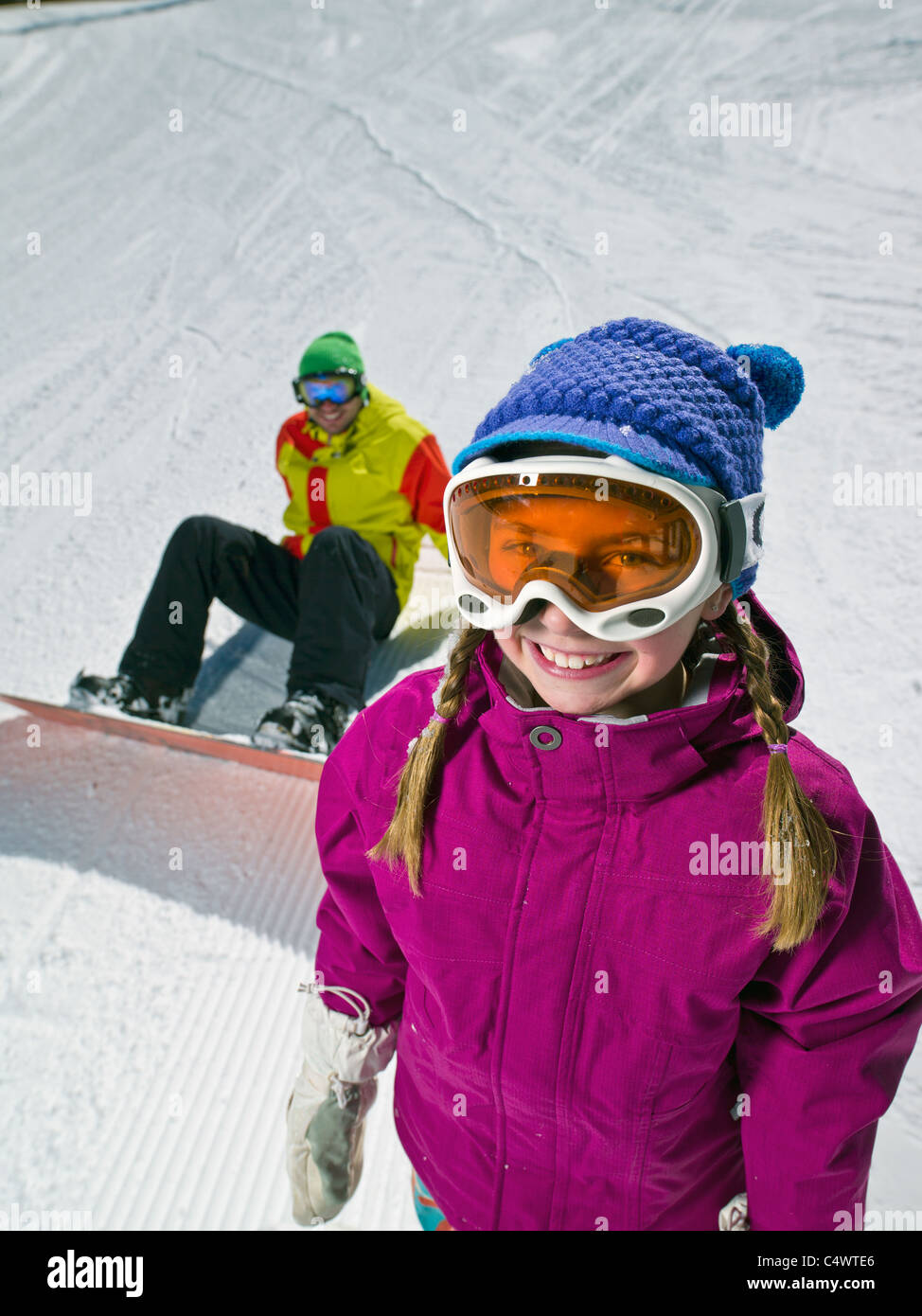 USA,Colorado,Telluride,Daughter (10-11) posing with father sitting on ...