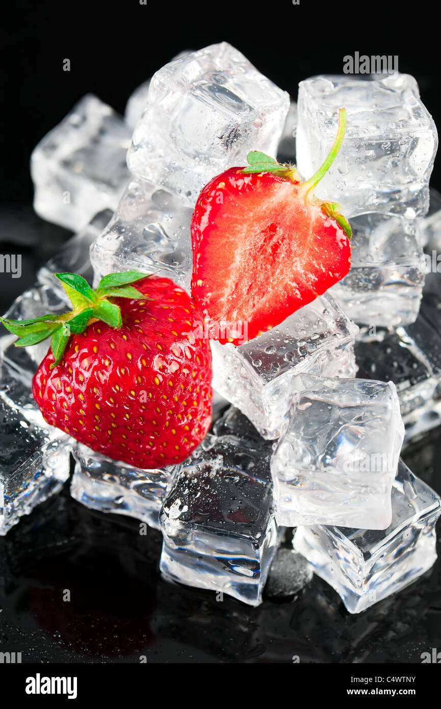 Fresh ripe strawberries with ice cubes on black surface Stock Photo - Alamy