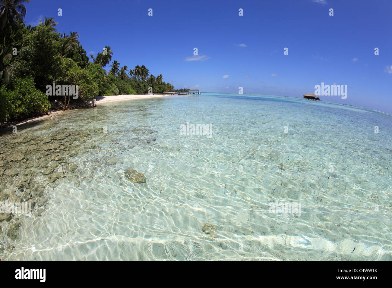 Deserted tropical beach with water bungalows in the distance Stock ...