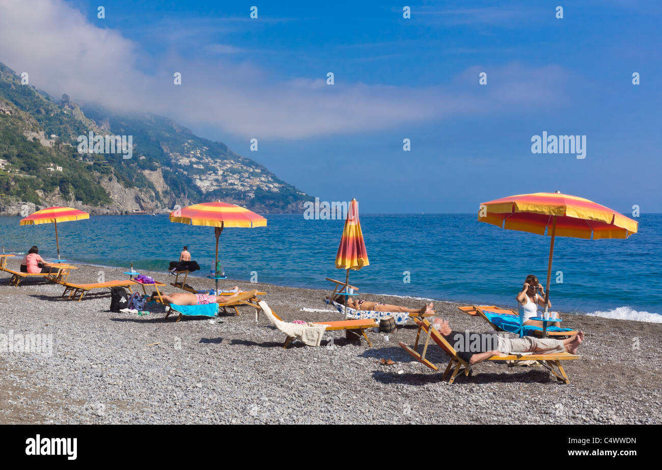 Italy - Positano. Colourful beach parasol shades and traditional wooden ...