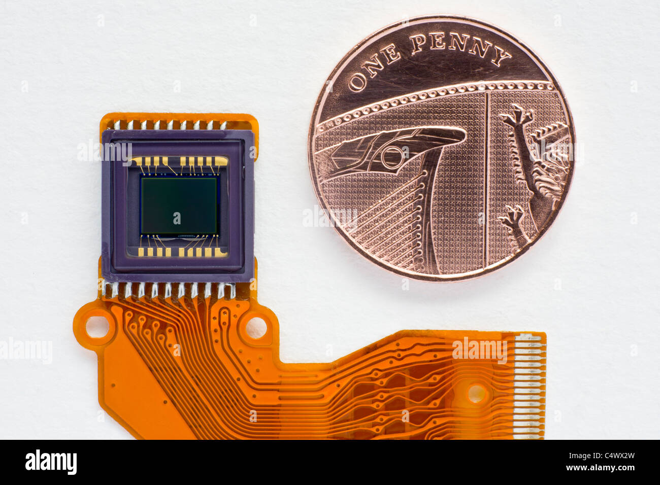 Compact camera sensor alongside a UK one penny piece for scale Stock ...