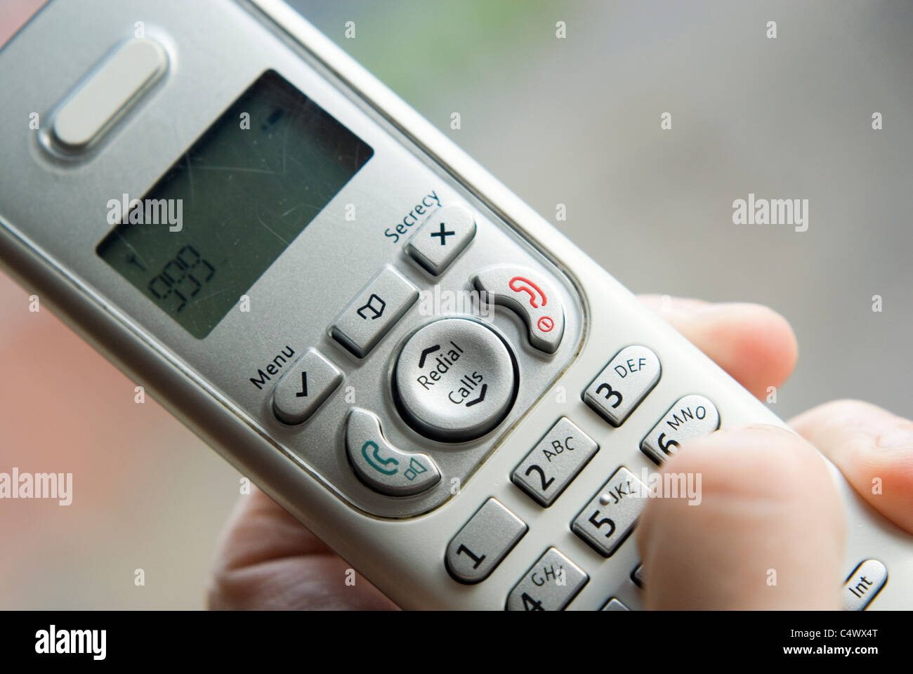 Close up on Hand Holding Telephone and Dialing 999 Emergency Rescue ...