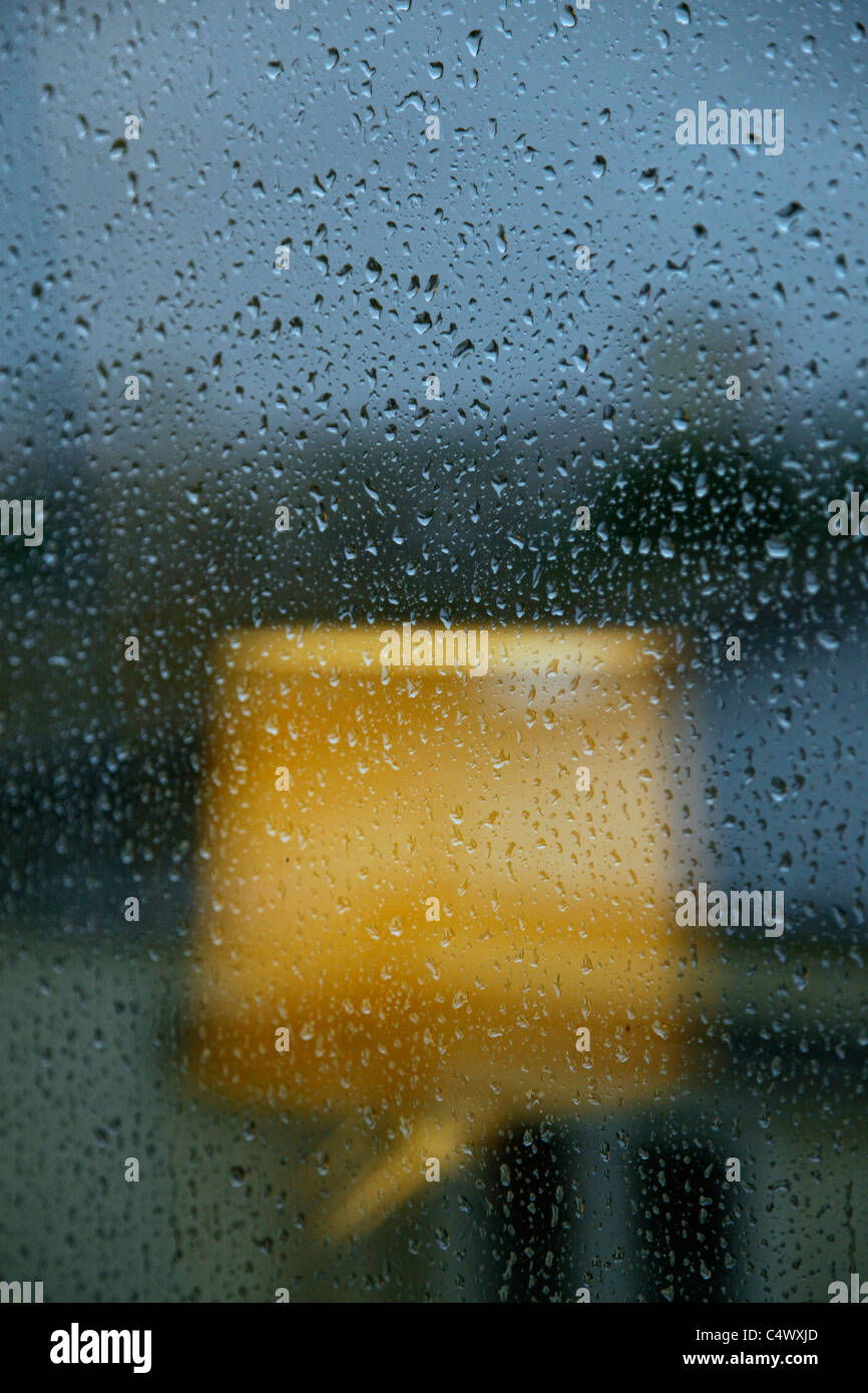Raindrops in a window with reflection of a house lamp Stock Photo - Alamy