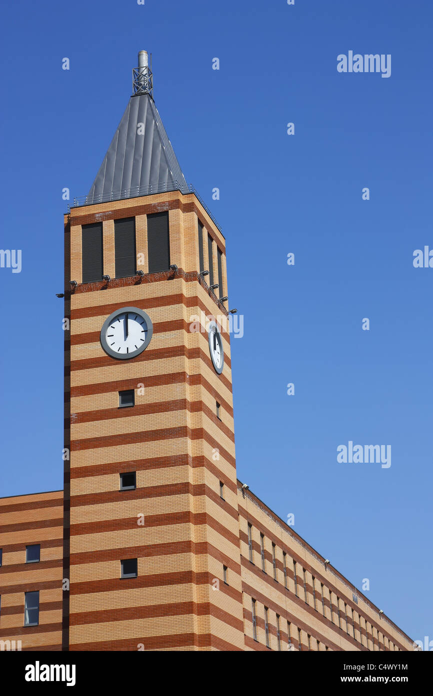 It depicts a brick building with clock tower type Stock Photo - Alamy