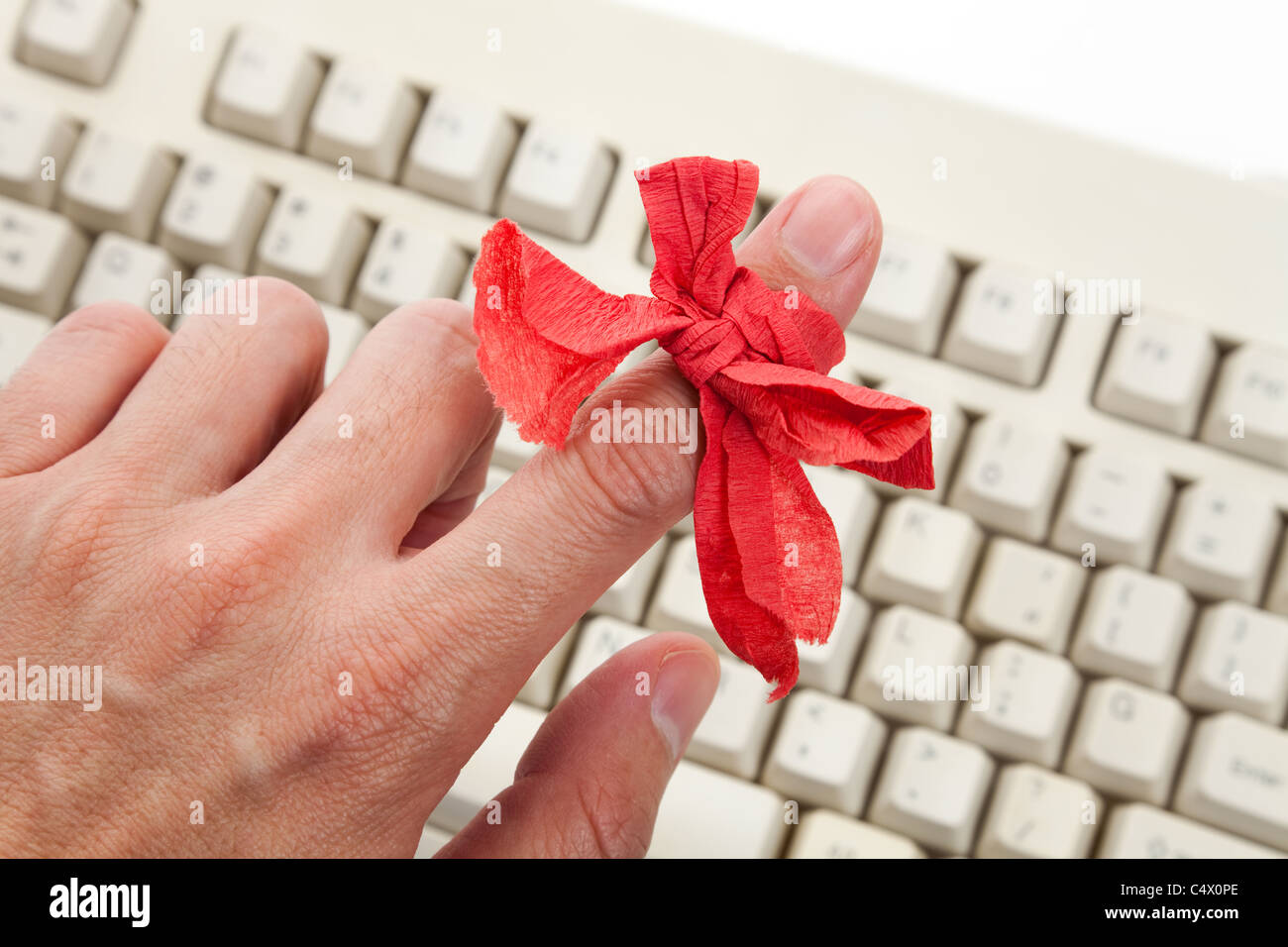 Red bow on finger computer hi-res stock photography and images - Alamy