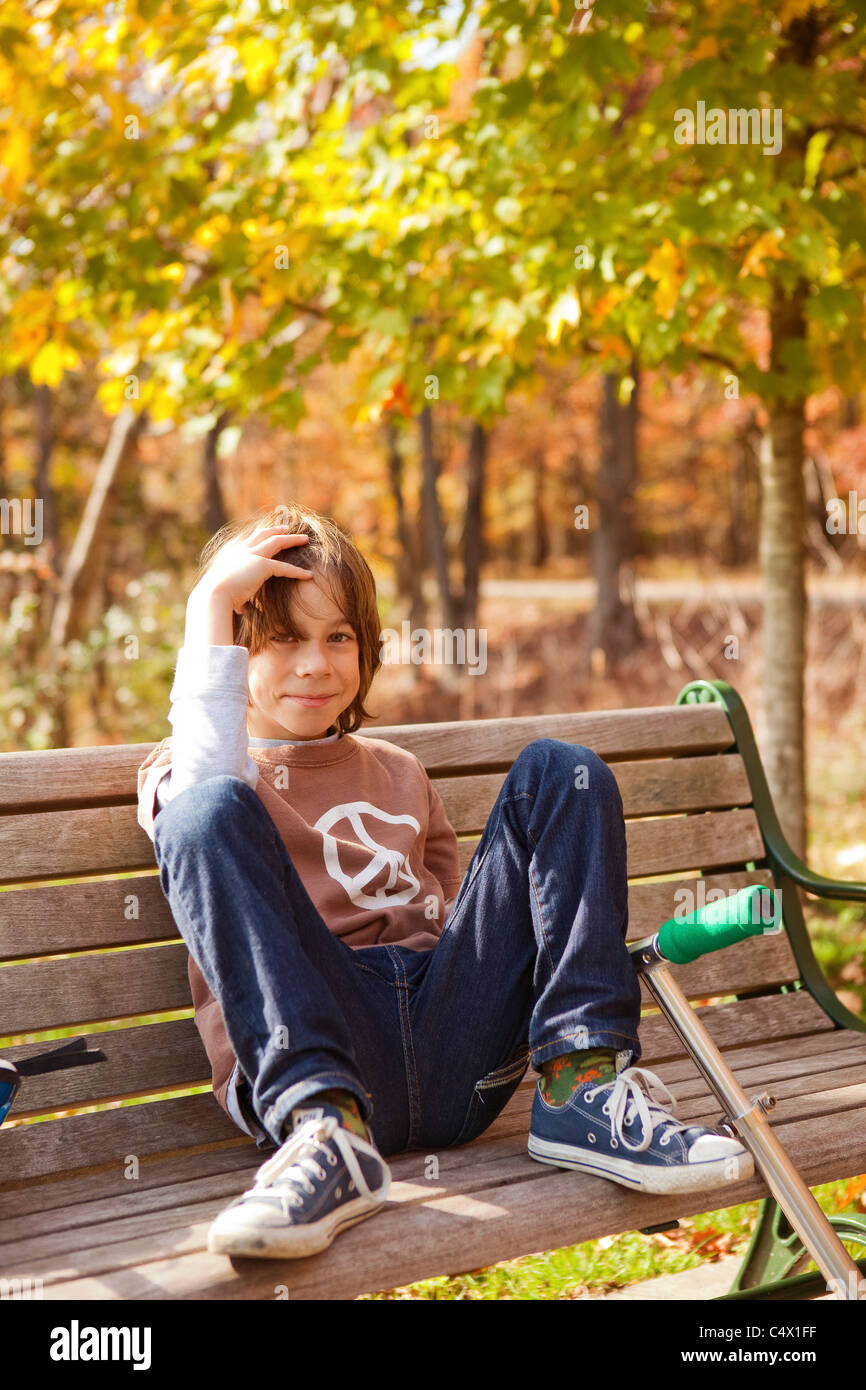 boy sitting on bench Stock Photo - Alamy