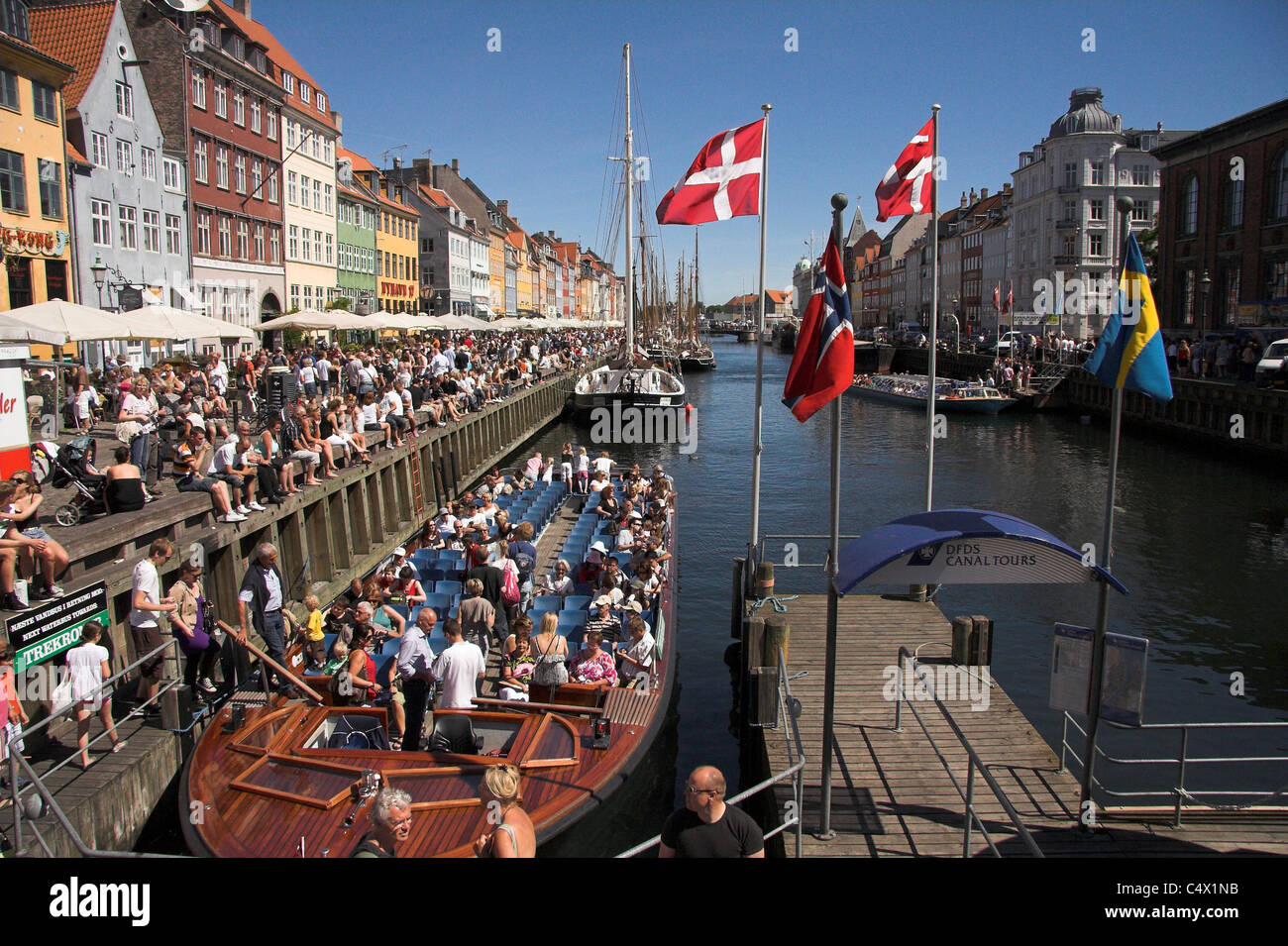 Tourists and boats on the popular waterfront, Nyhavn Harbour ...