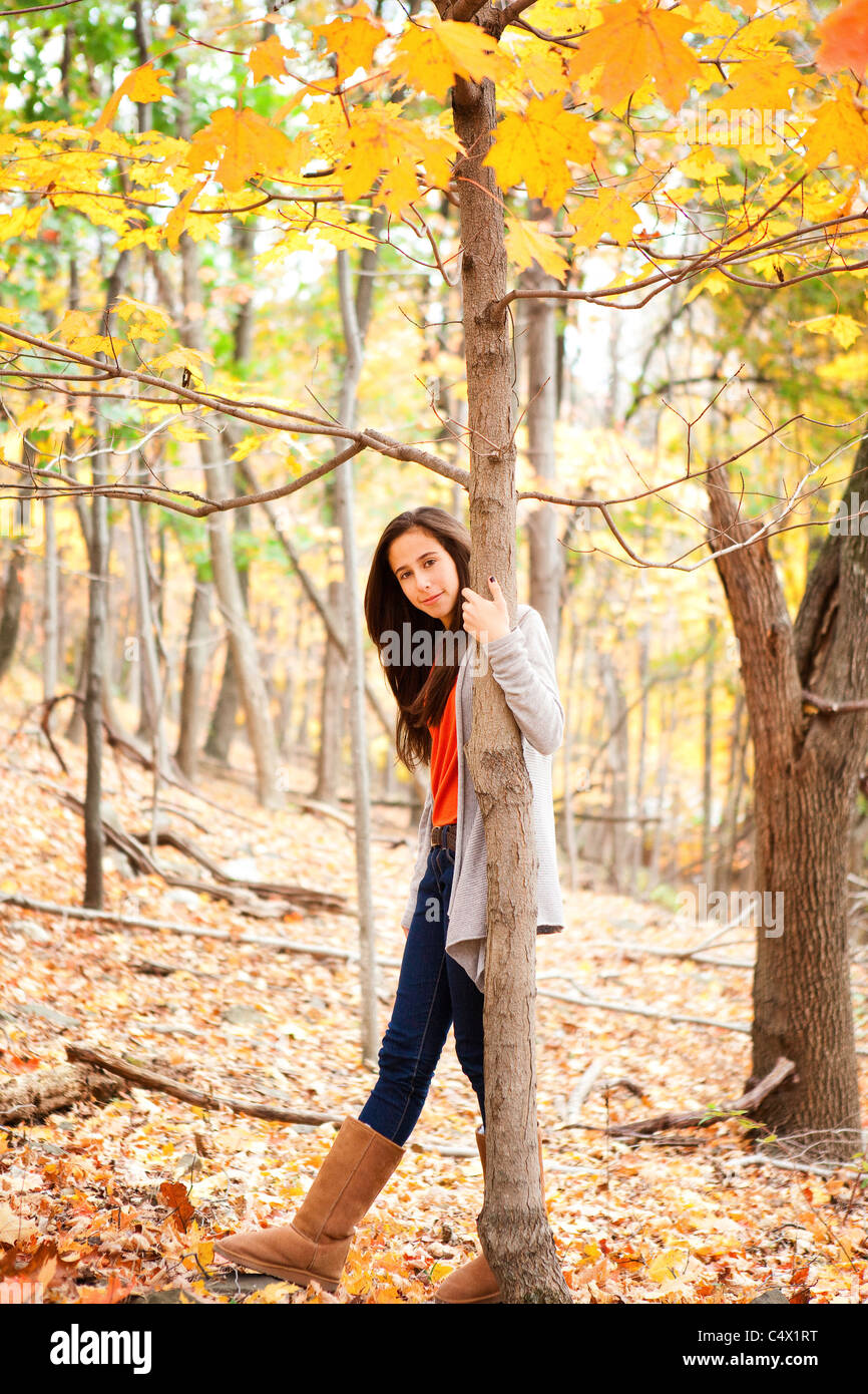 teenager girl holding on to tree Stock Photo - Alamy