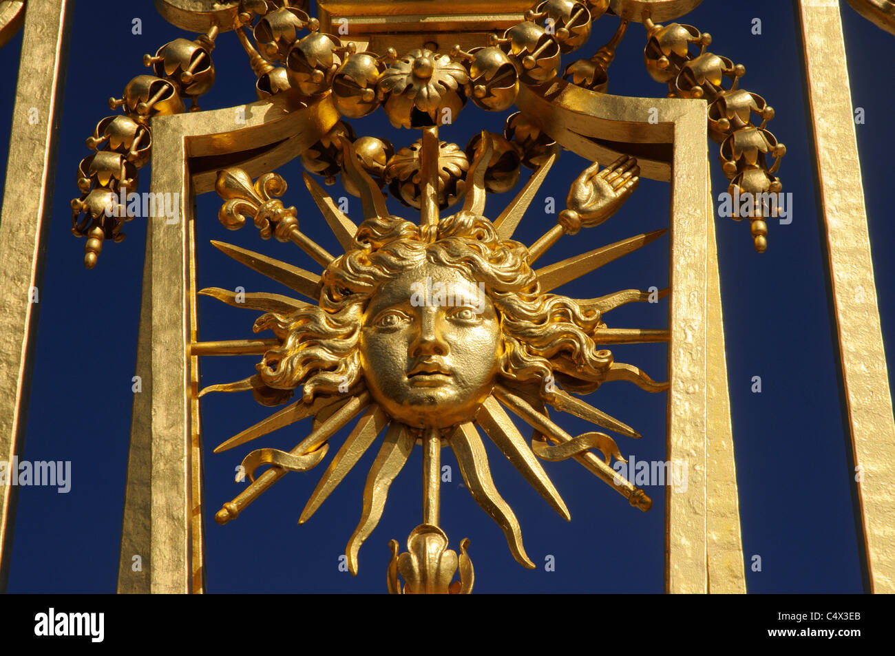 Golden portraits of King Louis 14th on the golden gate at Versailles ...