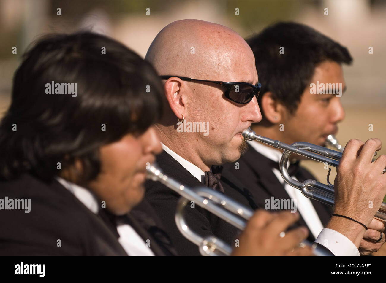 At the Fullerton graduation ceremony a picture of three men playing ...