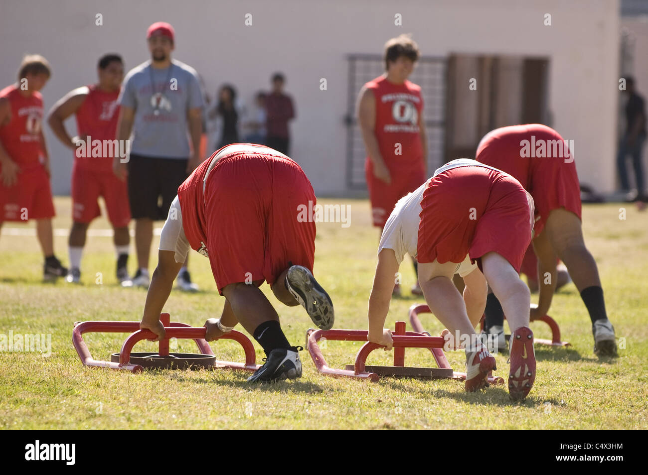 High school football players running sprints Stock Photo - Alamy