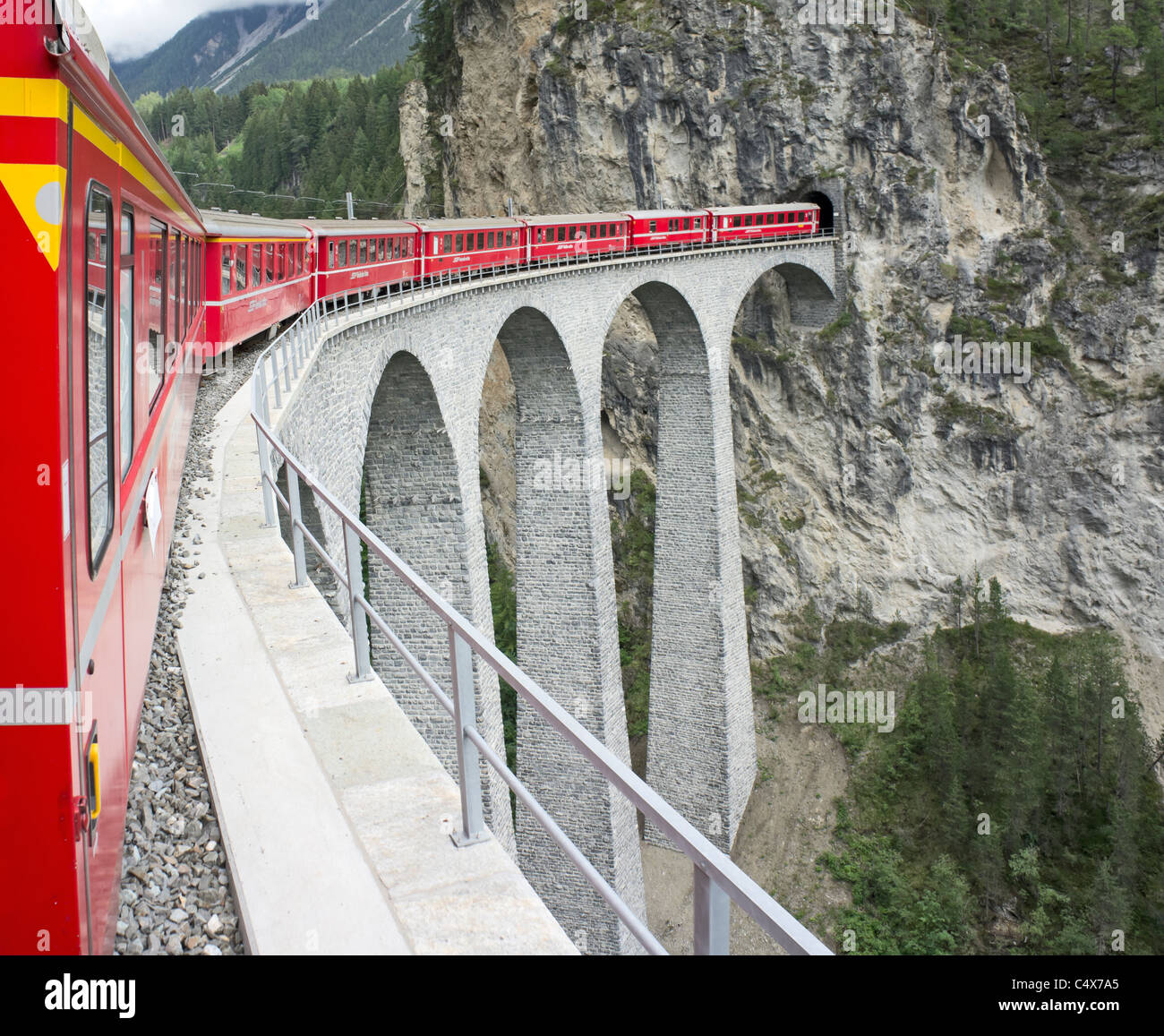Rhätische Bahn train from St. Moritz to Chur has just left Filisur and ...
