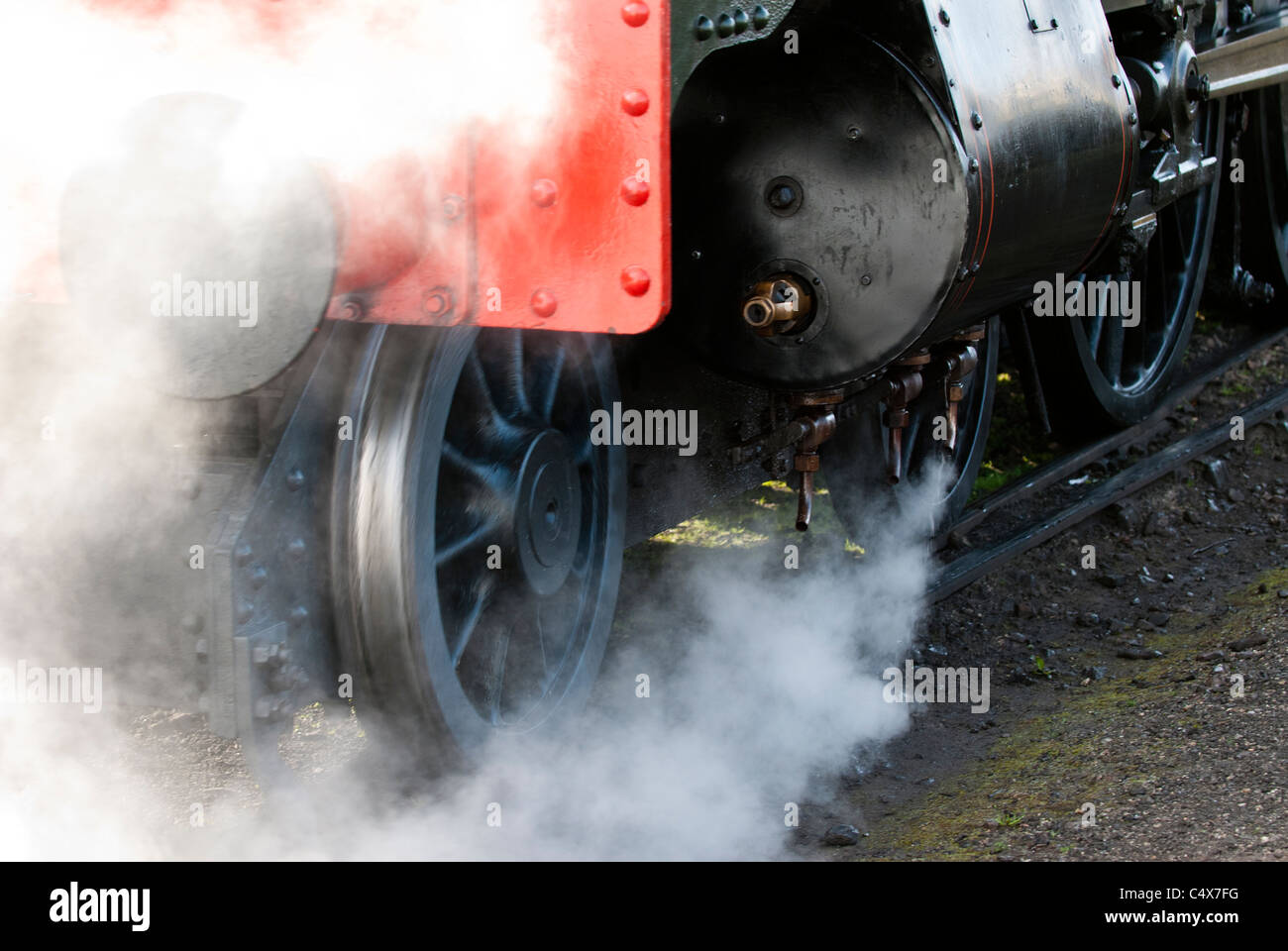 Vintage steam engine with steam bellowing from beneath. Gloucester and ...