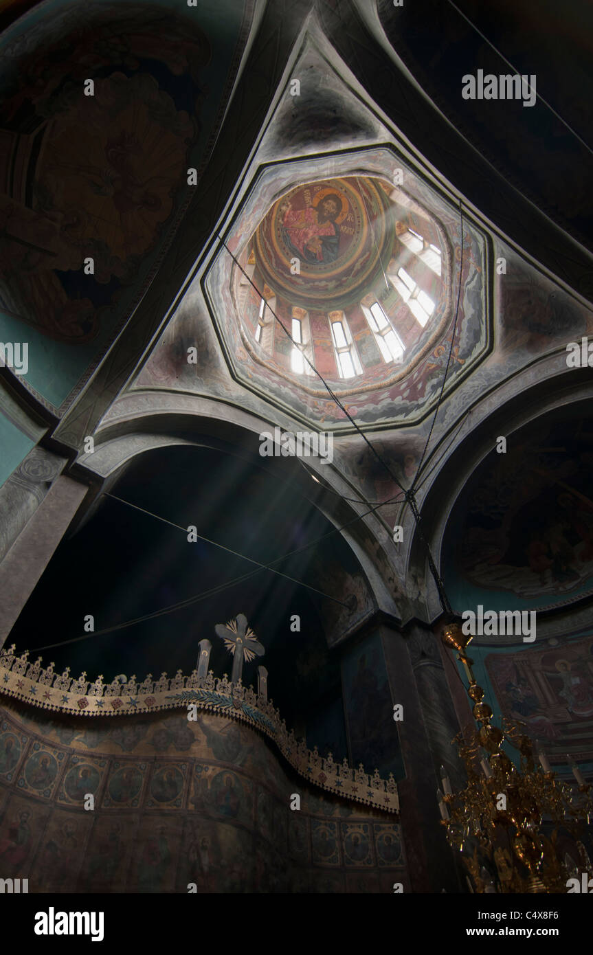 Christian orthodox church interior with ray of light in Romania, Brebu ...