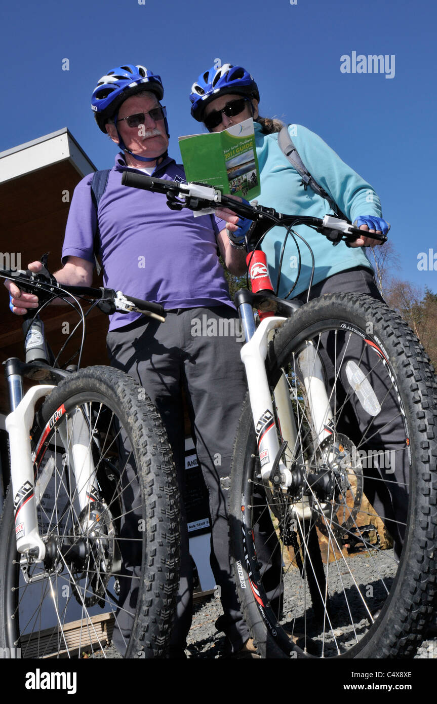 Cyclists choosing a cycle route in Kielder Water & Forest Park ...