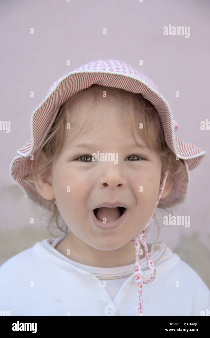 The innocent looks of a little girl on a simple background Stock Photo ...