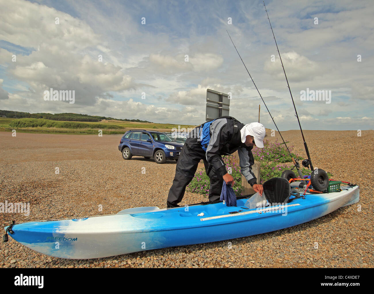 A kayak angler returning to his car after a day fishing for bass off ...