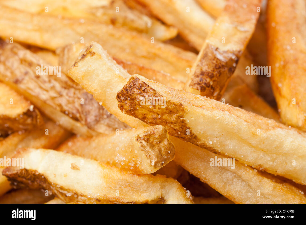 A group of hot french fries against a white background Stock Photo - Alamy