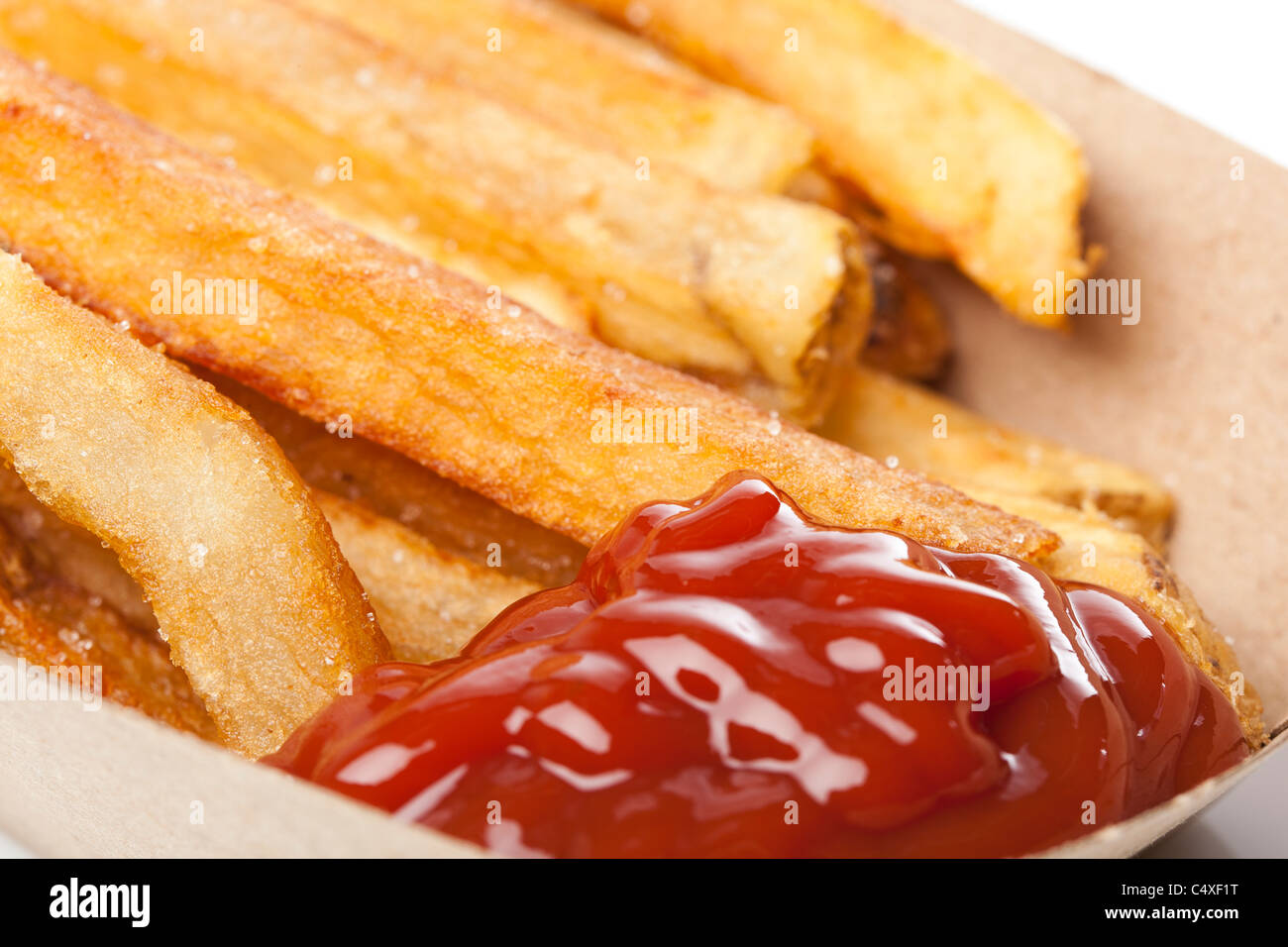 A group of hot french fries against a white background Stock Photo - Alamy