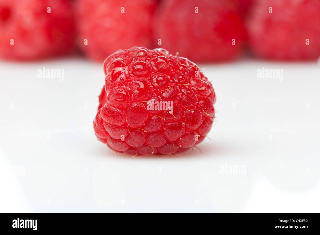 Fresh red raspberries against a white background Stock Photo - Alamy
