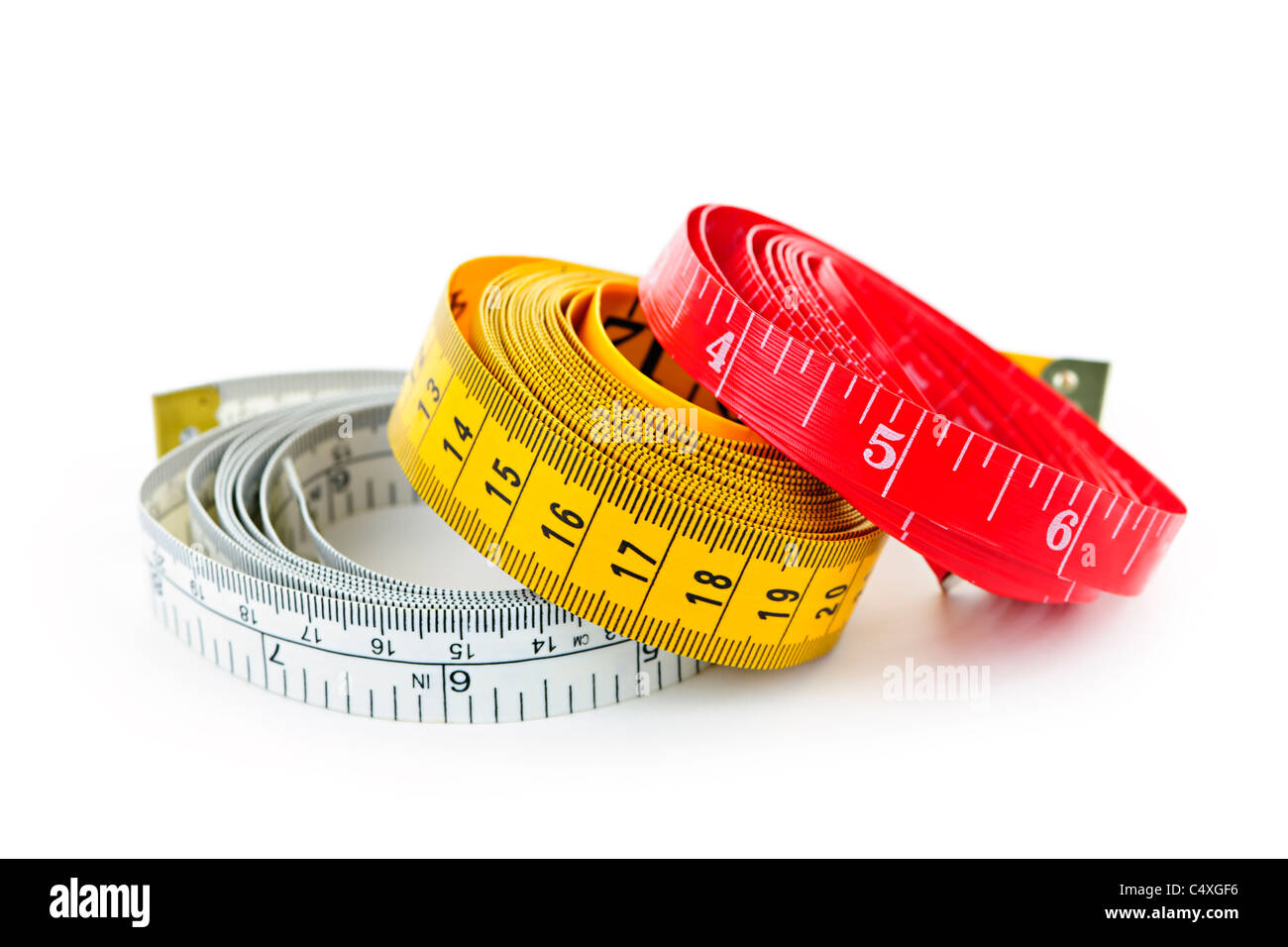 Three colorful measuring tapes coiled on white background Stock Photo ...