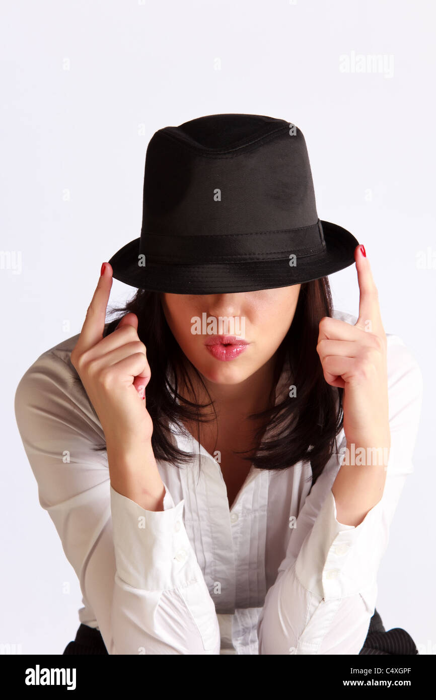 Young woman hides face under the hat with brim Stock Photo - Alamy