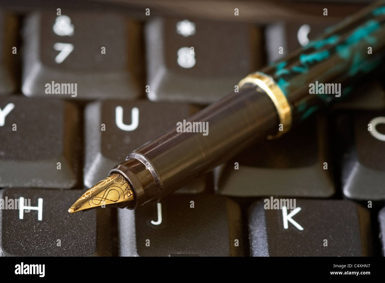 A fountain pen on a computer keyboard Stock Photo - Alamy