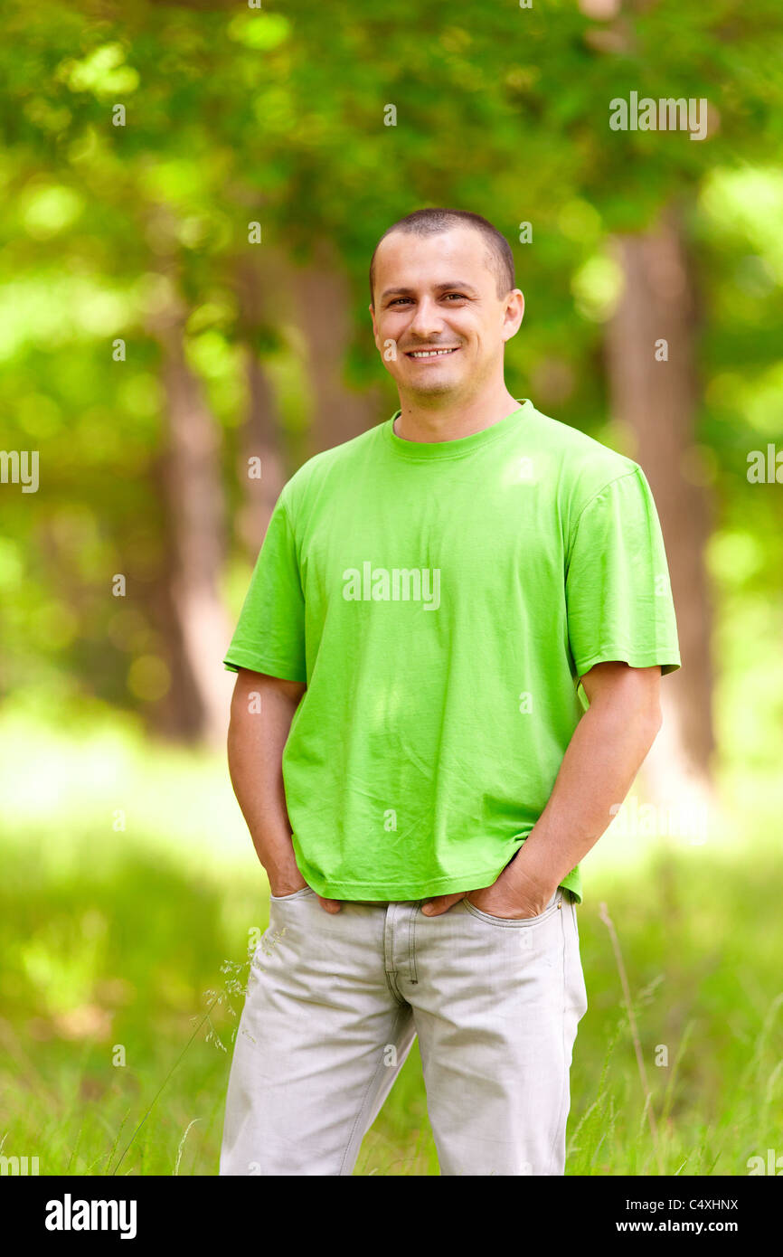 Portrait of a happy young man in a forest Stock Photo - Alamy
