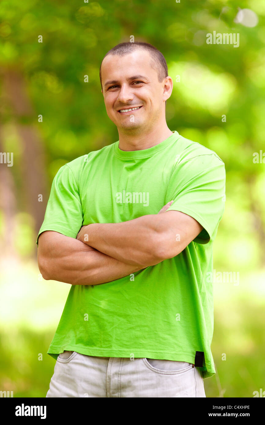 Portrait of a happy young man in a forest Stock Photo - Alamy