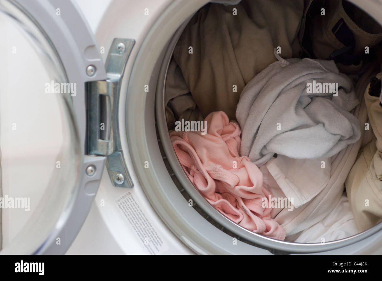 open washing machine with clothes in Stock Photo - Alamy