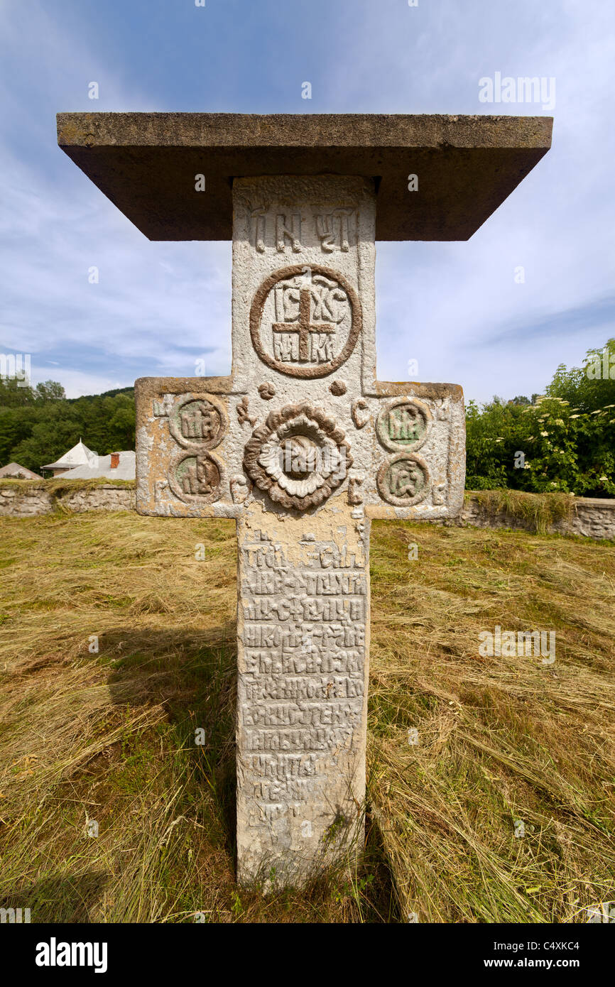 Ancient medieval embossed stone cross on a meadow in Romania Stock ...