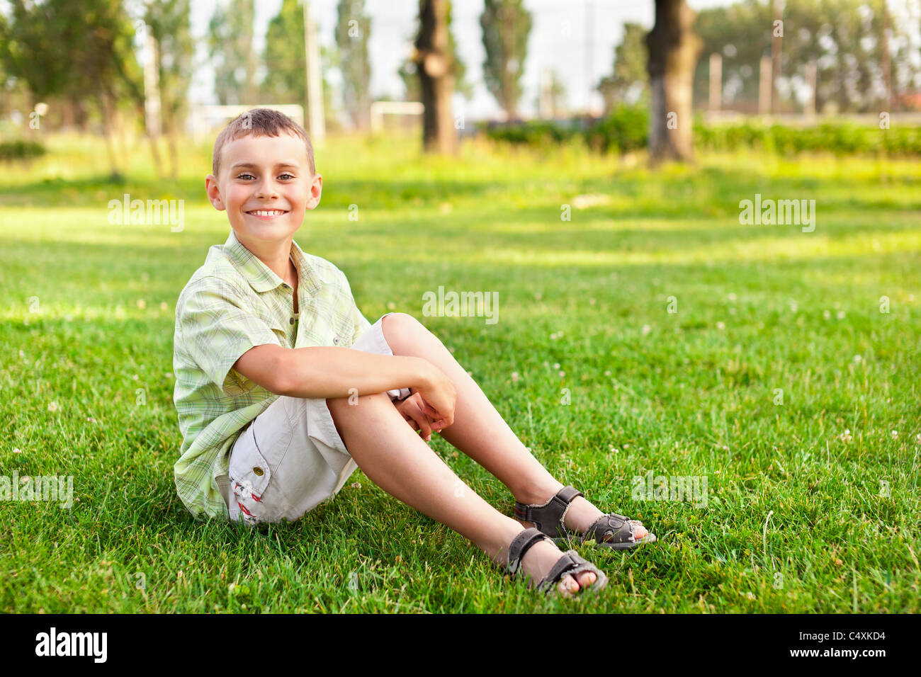 Portrait of a happy boy outdoor in a park Stock Photo - Alamy