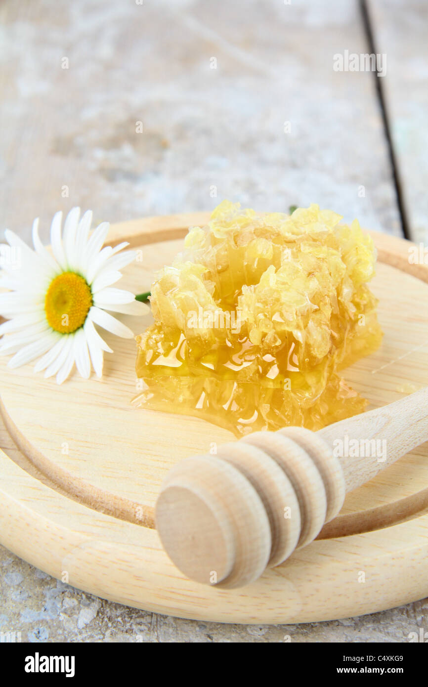 honeycomb on a wooden stand on the table Stock Photo - Alamy