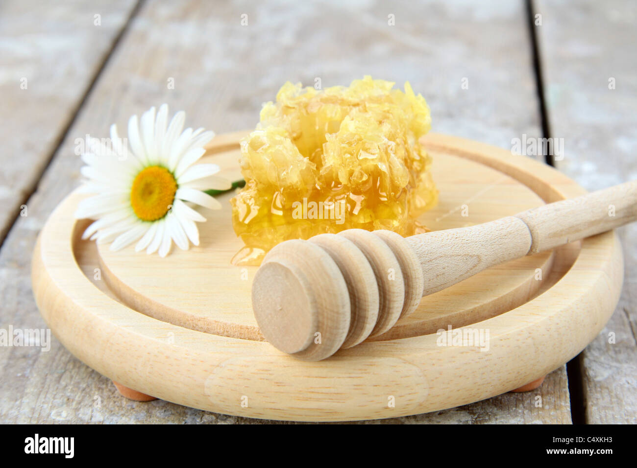 honeycomb on a wooden stand on the table Stock Photo - Alamy