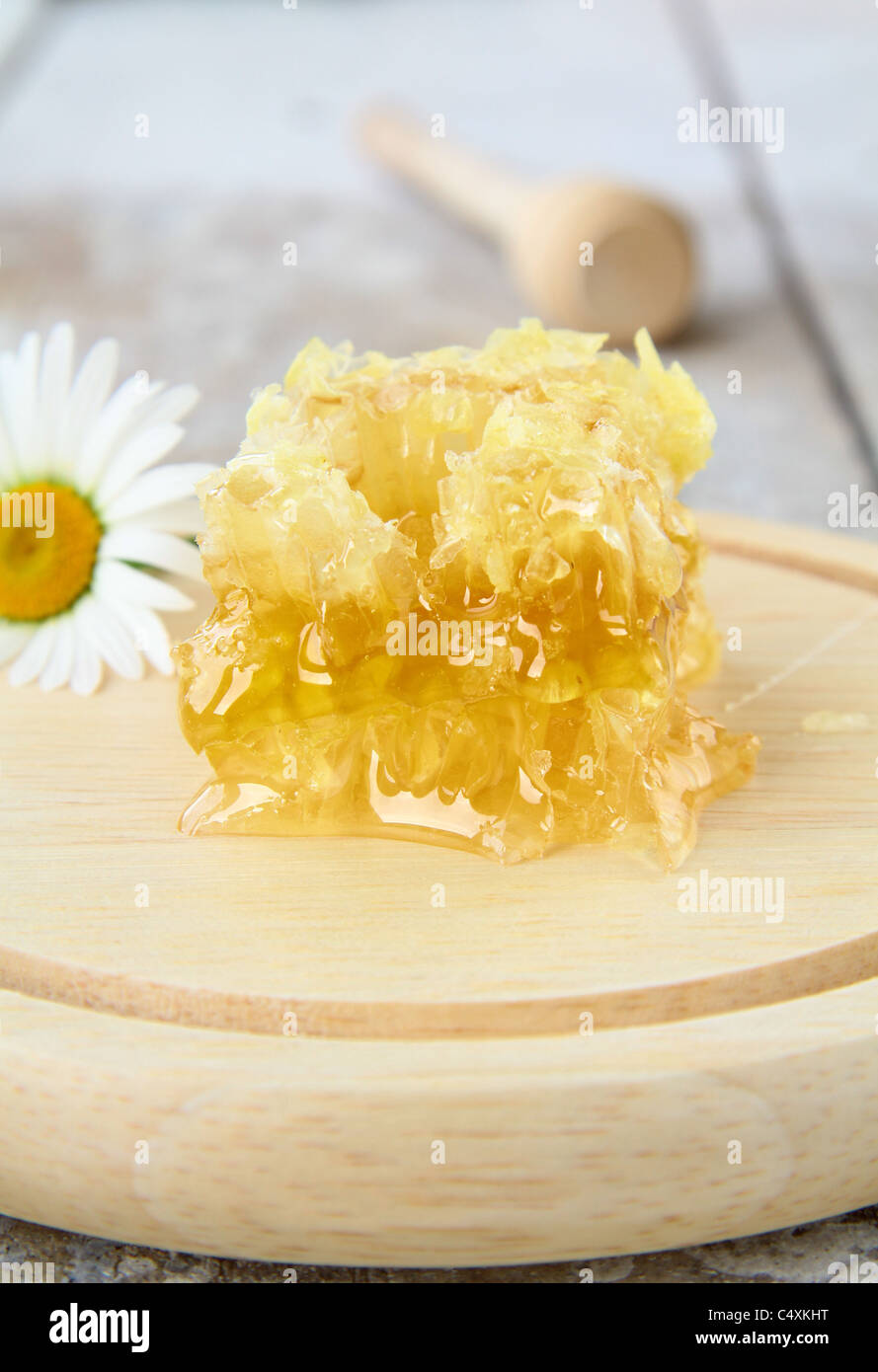 honeycomb on a wooden stand on the table Stock Photo - Alamy
