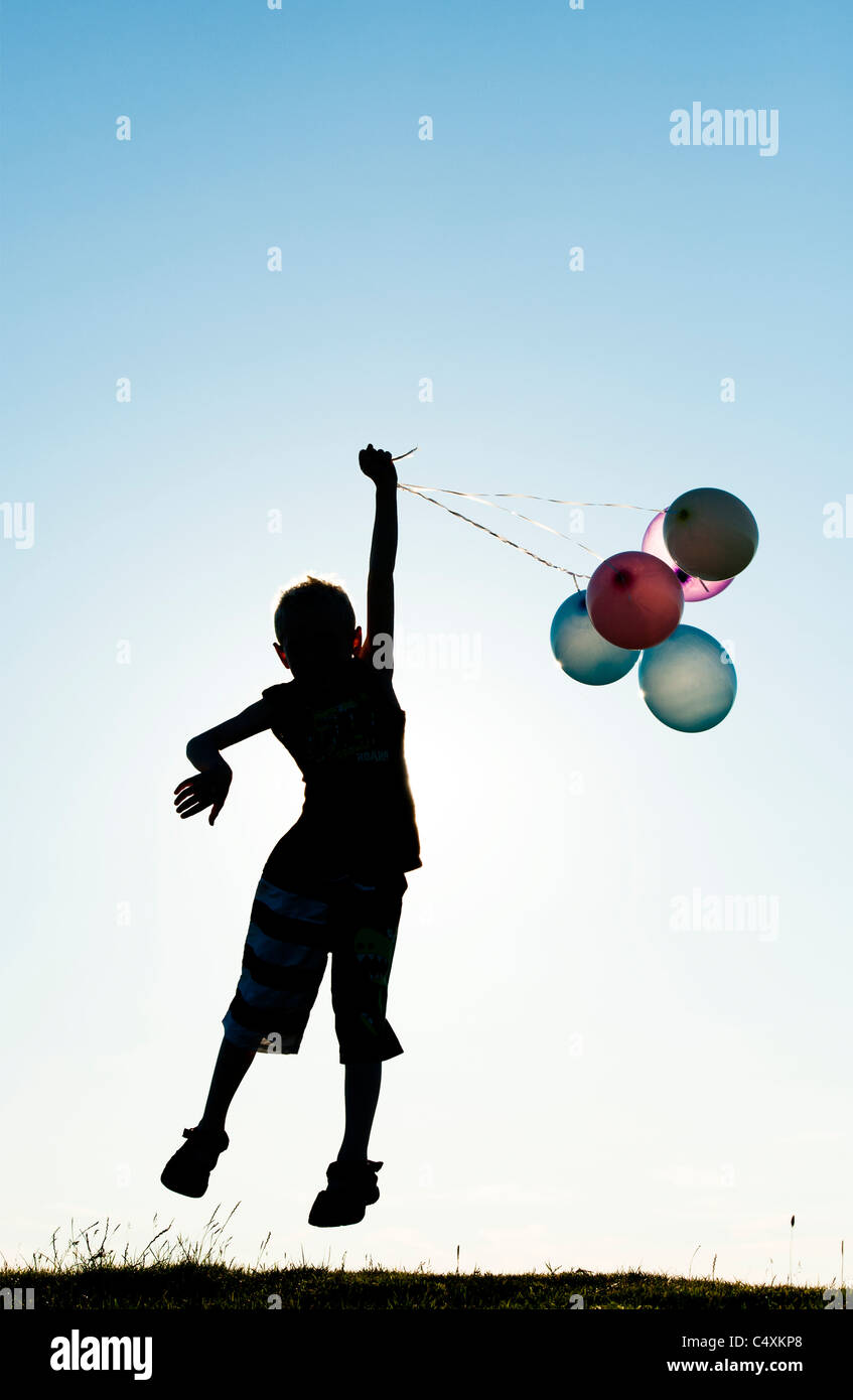 Boy Floating With Balloons High Resolution Stock Photography and Images ...