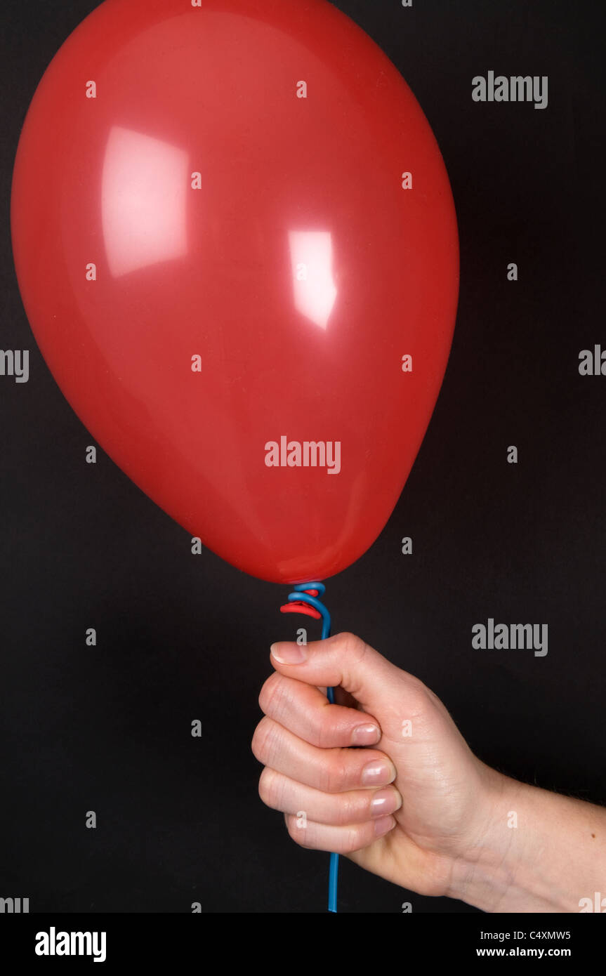 Hand on balloon hi-res stock photography and images - Alamy