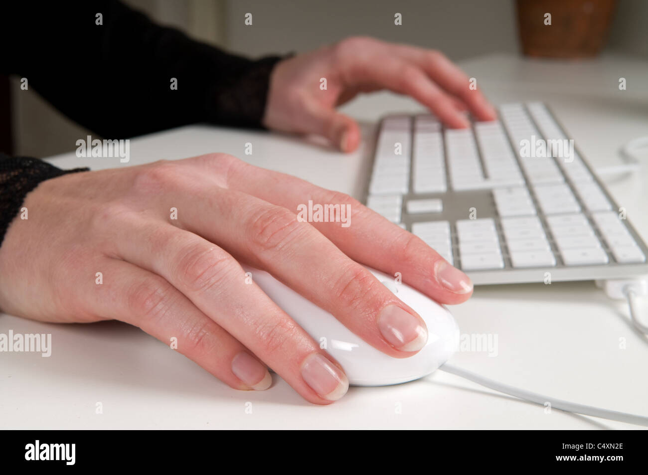 Working with a keyboard and mouse Stock Photo - Alamy
