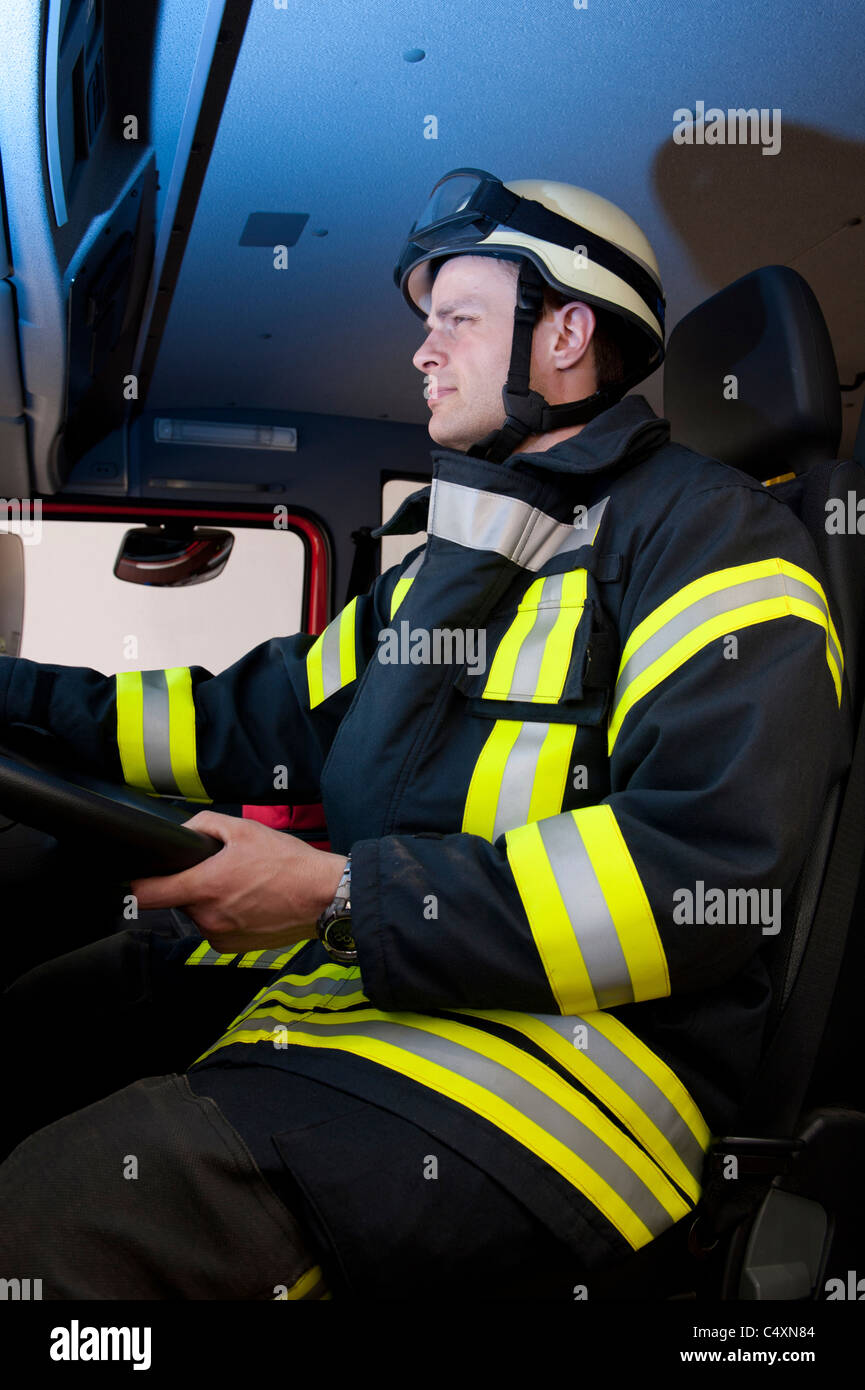 Picture from a young and successful firefighter at work Stock Photo - Alamy