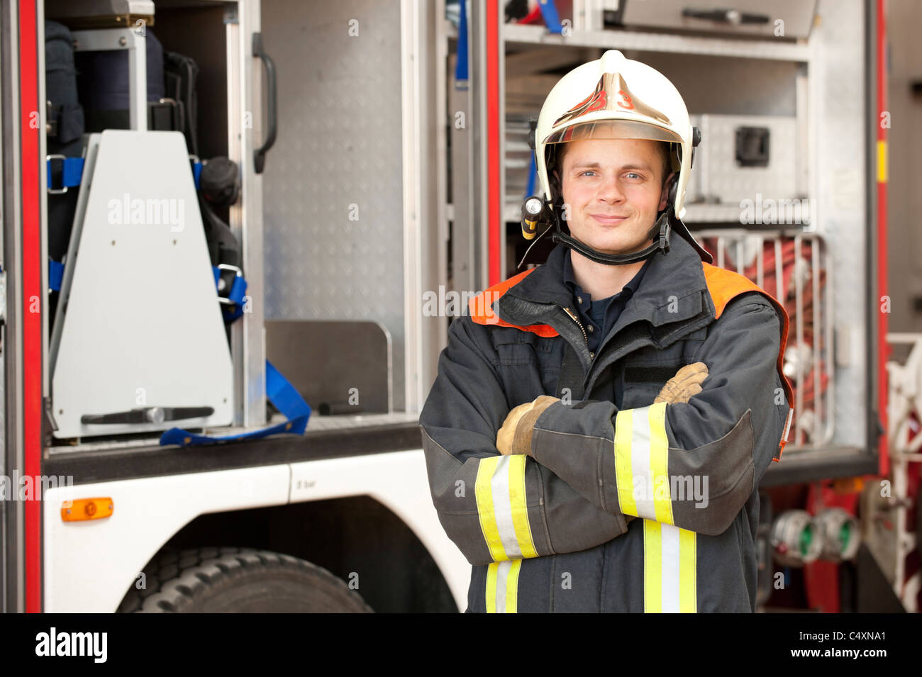 Picture from a young and successful firefighter at work Stock Photo - Alamy