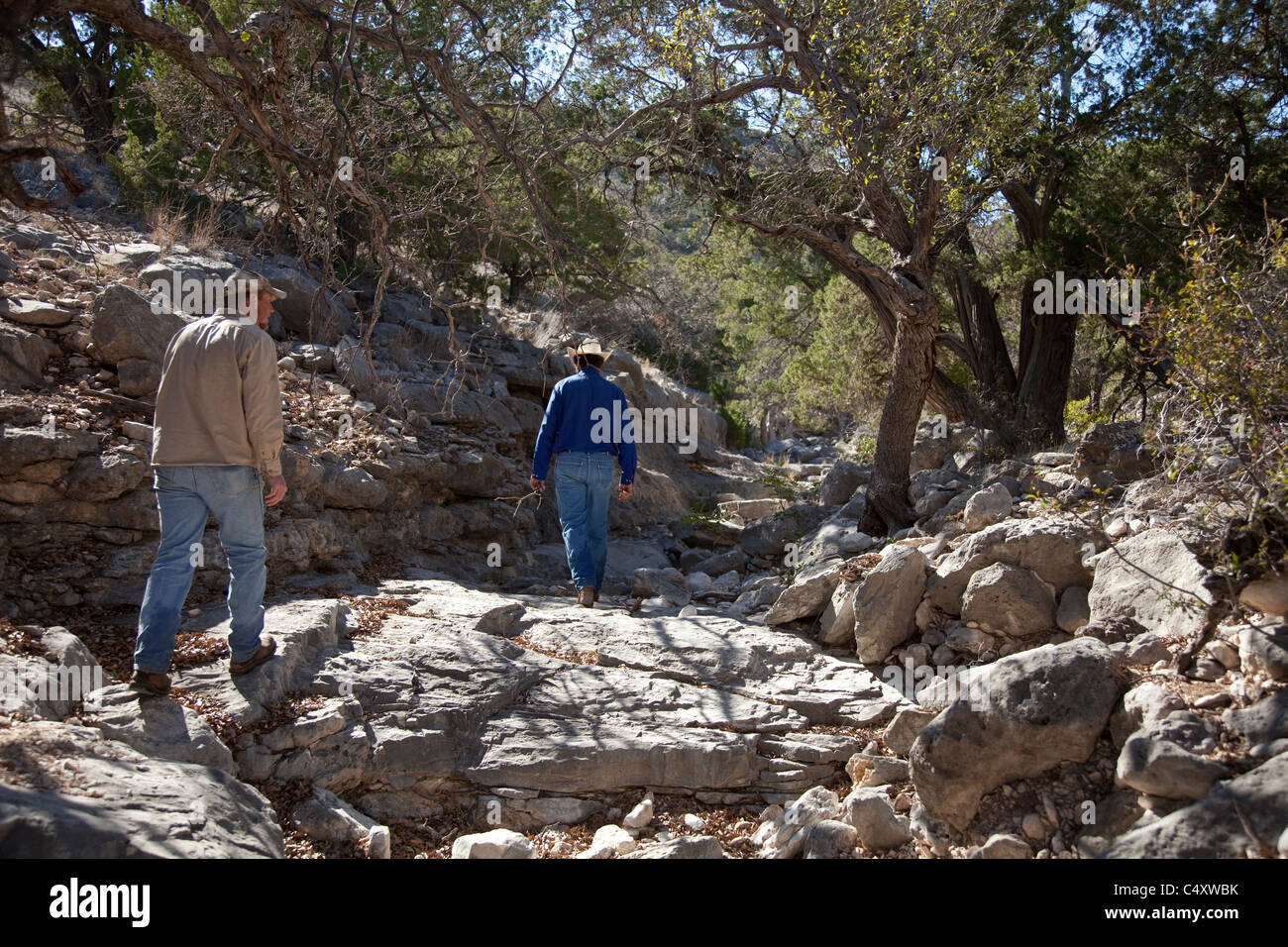 Hikers on private ranch near Sheffield, Texas, hike out of a canyon ...