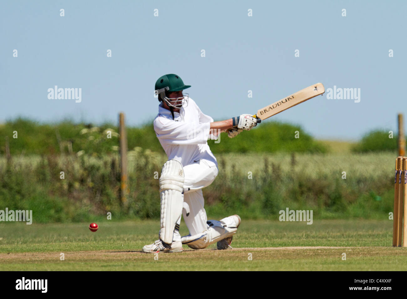 Showing the follow through of a batsman playing a shot Stock Photo - Alamy