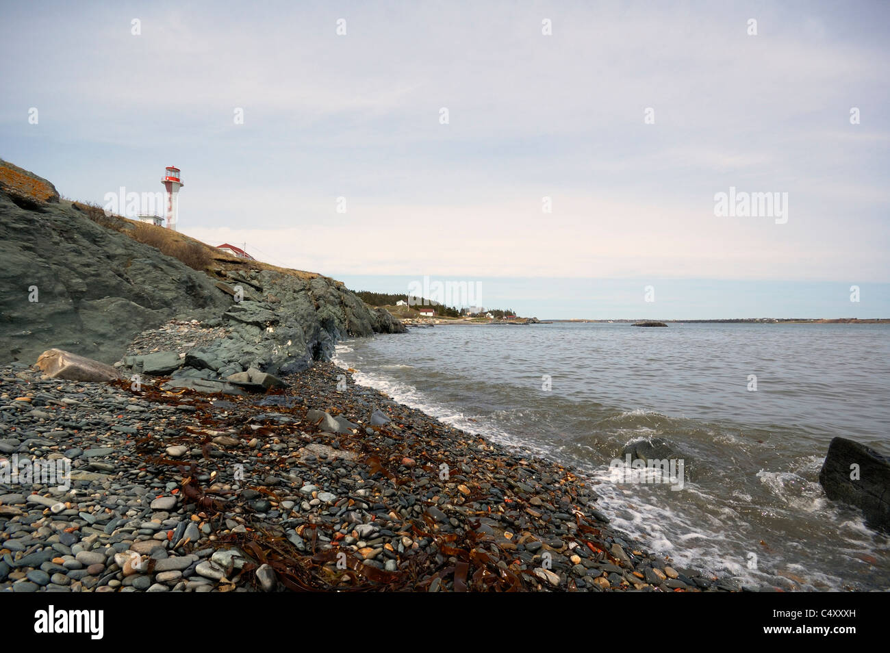 Wide angle view of a coastline showing a lighthouse in the left hand ...