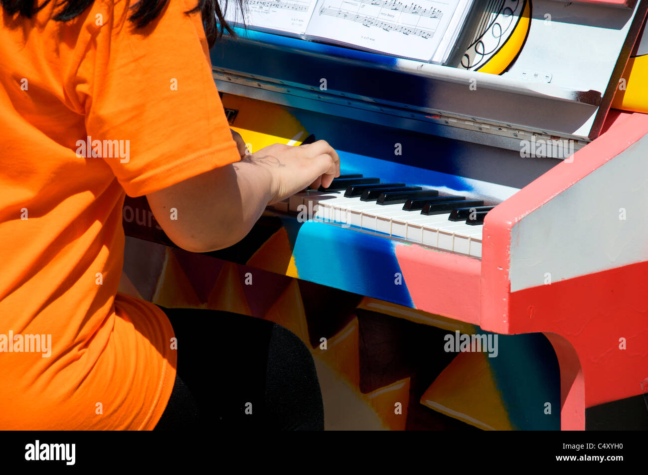 Music student plays street piano in Paternoster Square during the City ...