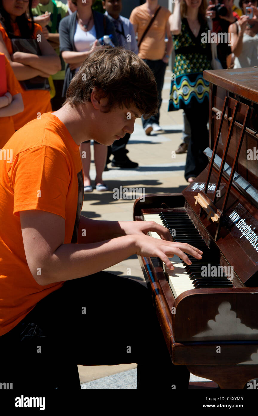 Music student plays street piano in Paternoster Square during the City ...